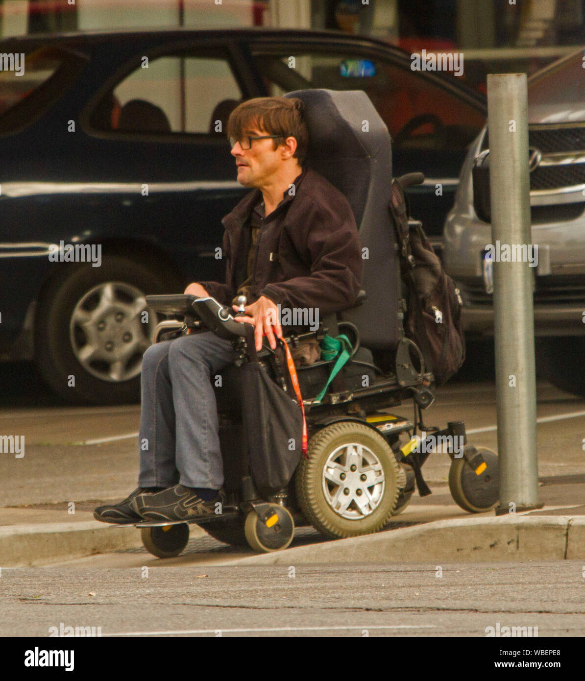 Disabled man in electric wheelchair Stock Photo - Alamy