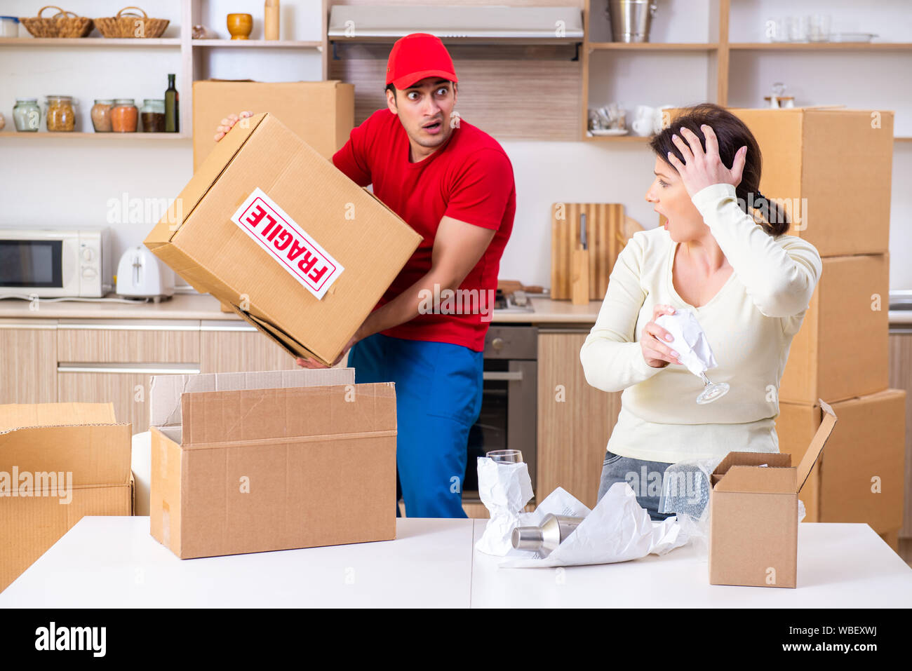 The young male contractor and female customer in moving concept Stock ...
