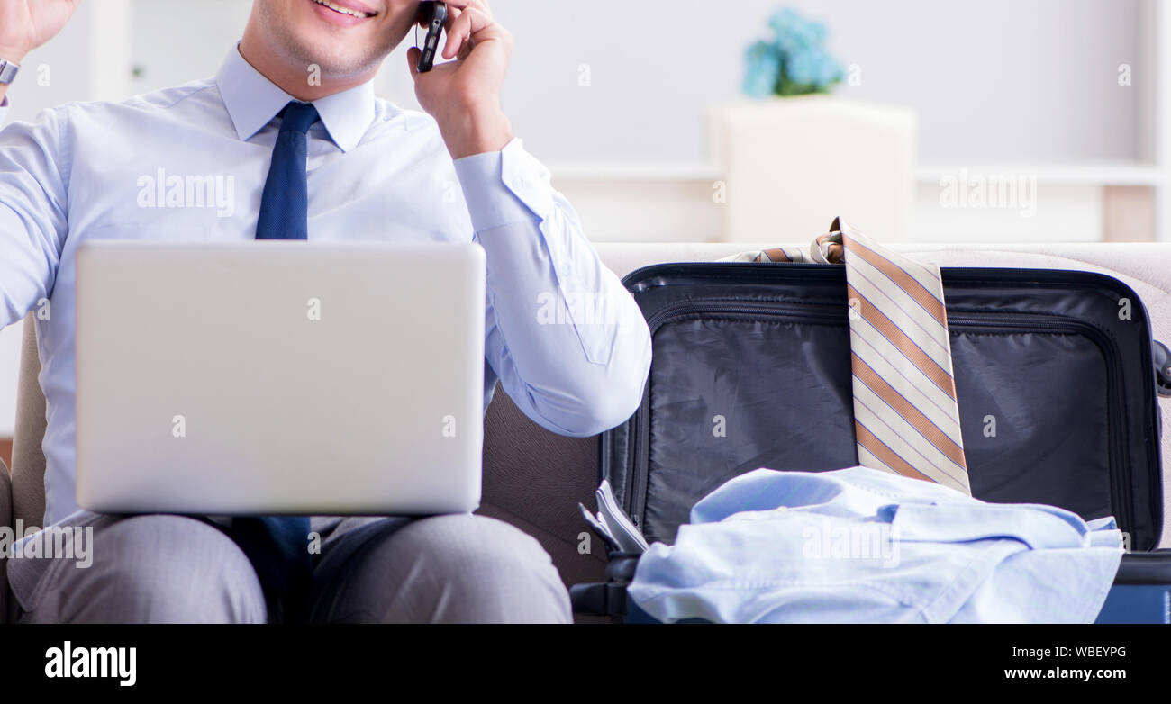 The businessman preparing packing for business trip Stock Photo - Alamy