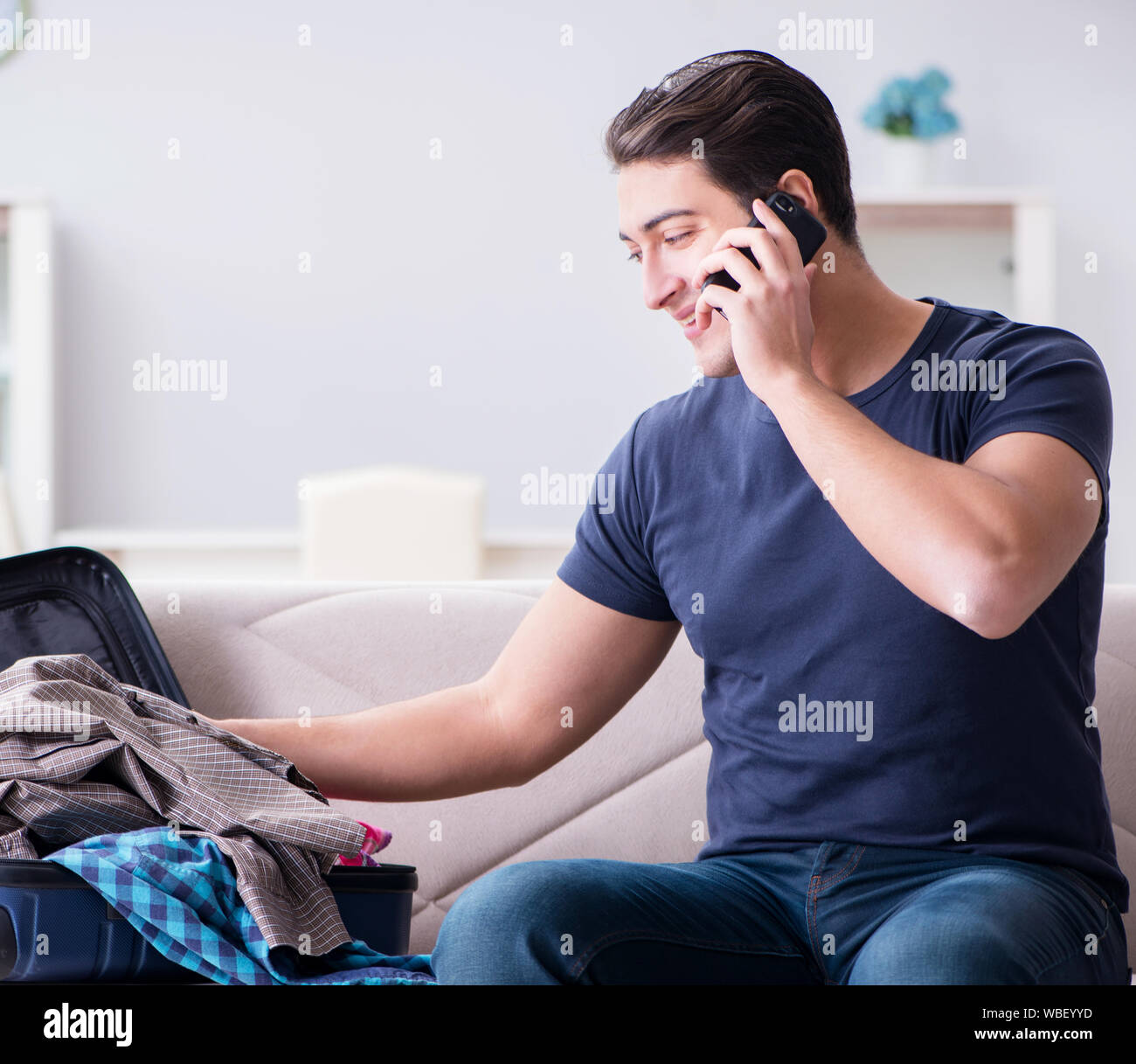 The young man preparing packing for summer vacation Stock Photo - Alamy