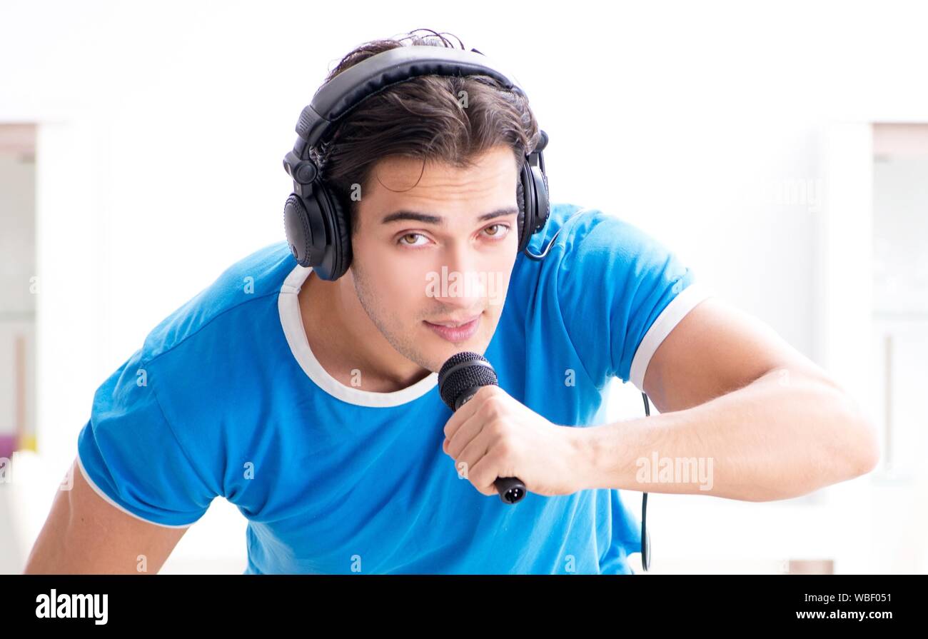 The young man singing at home karaoke Stock Photo - Alamy