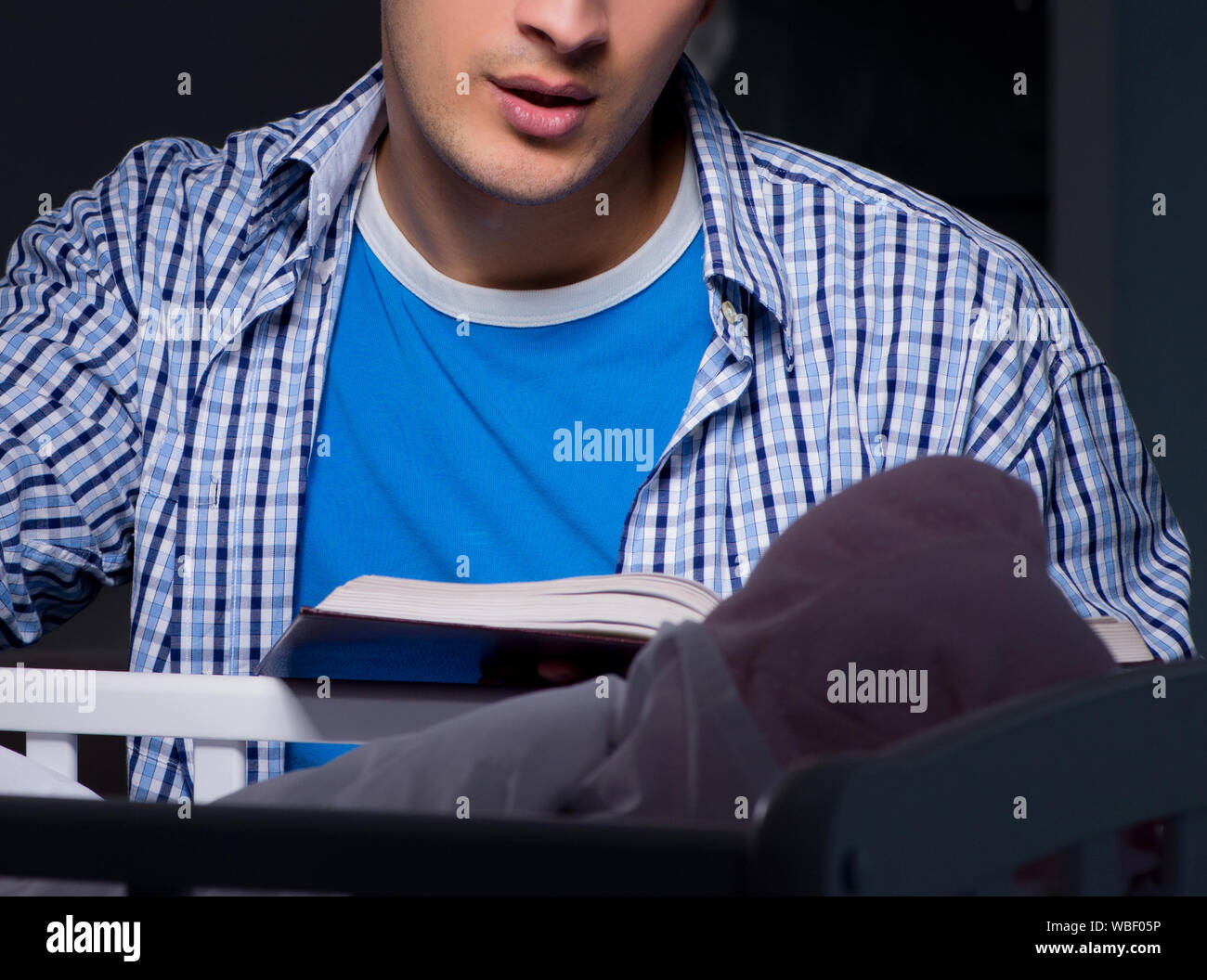 The young student doing homework and looking after newborn baby Stock ...