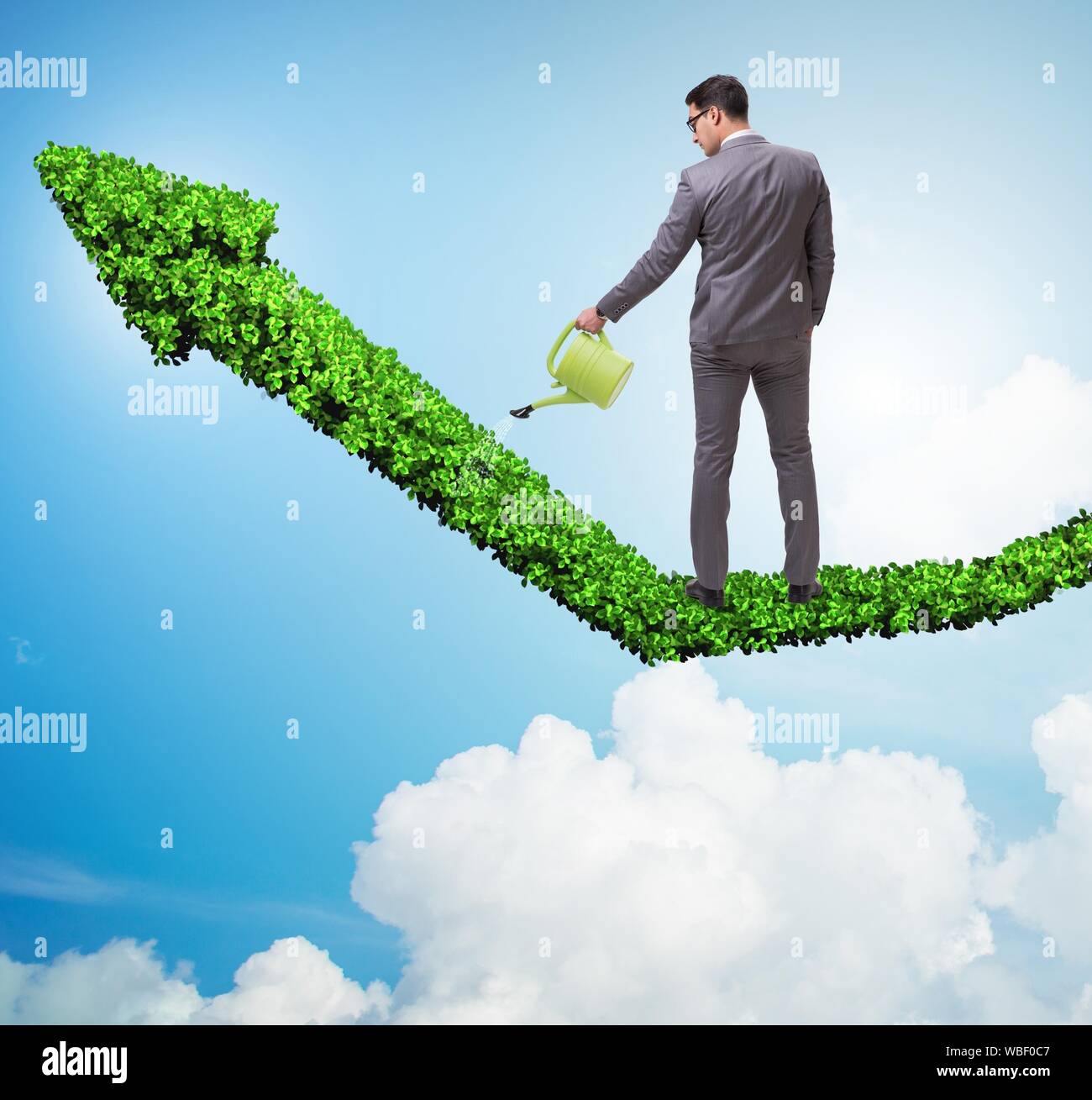 The businessman in investment concept watering financial line chart ...
