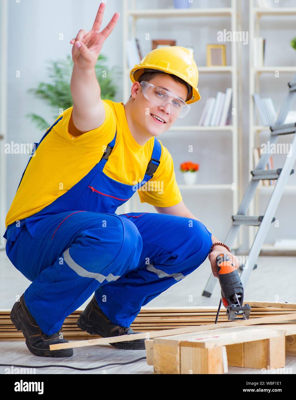 The young man assembling wood pallet Stock Photo - Alamy