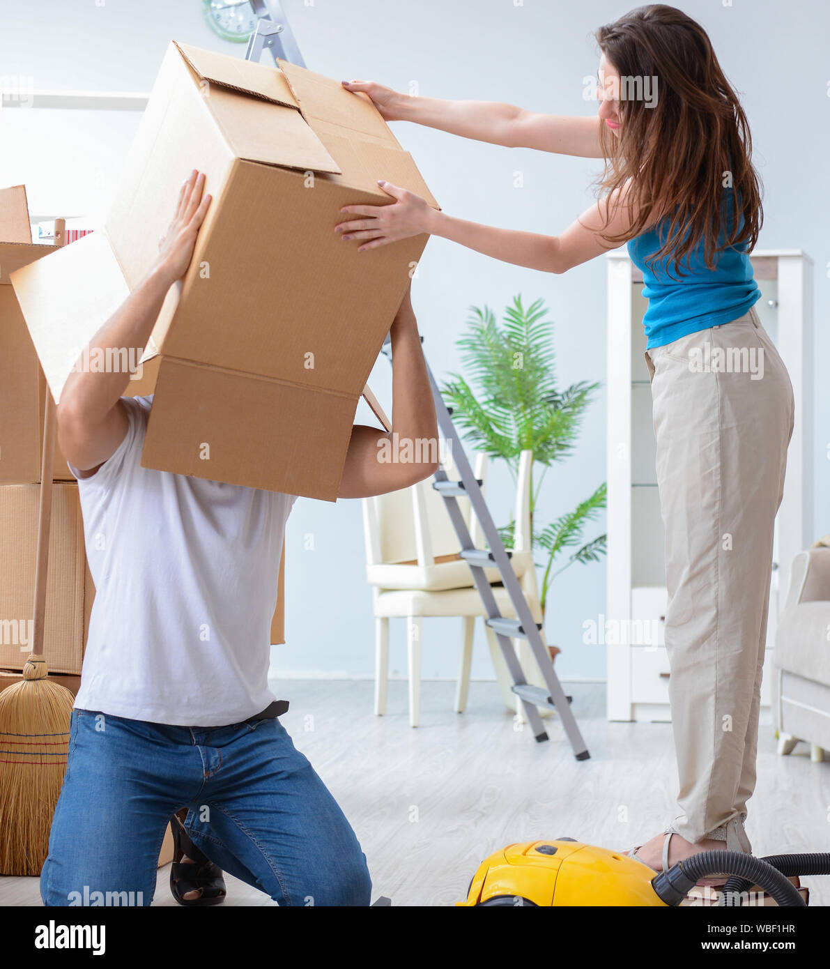 The young family unpacking at new house with boxes Stock Photo - Alamy
