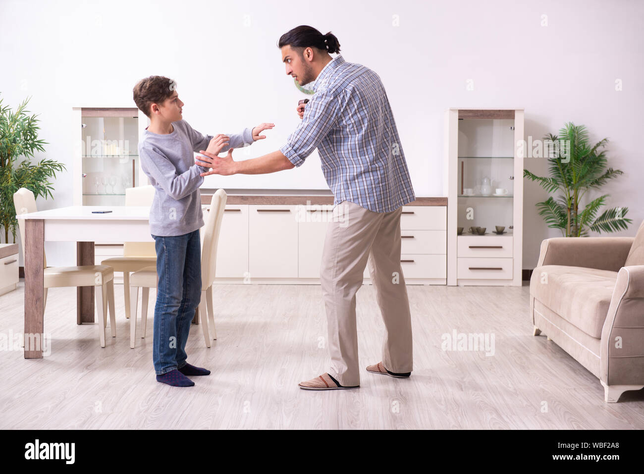 The father beating and punishing his sone Stock Photo - Alamy