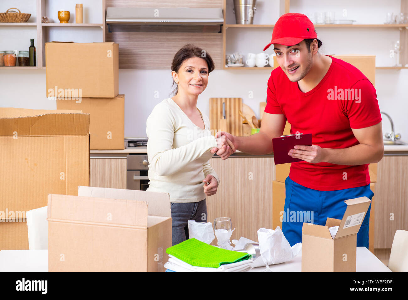 The young male contractor and female customer in moving concept Stock ...