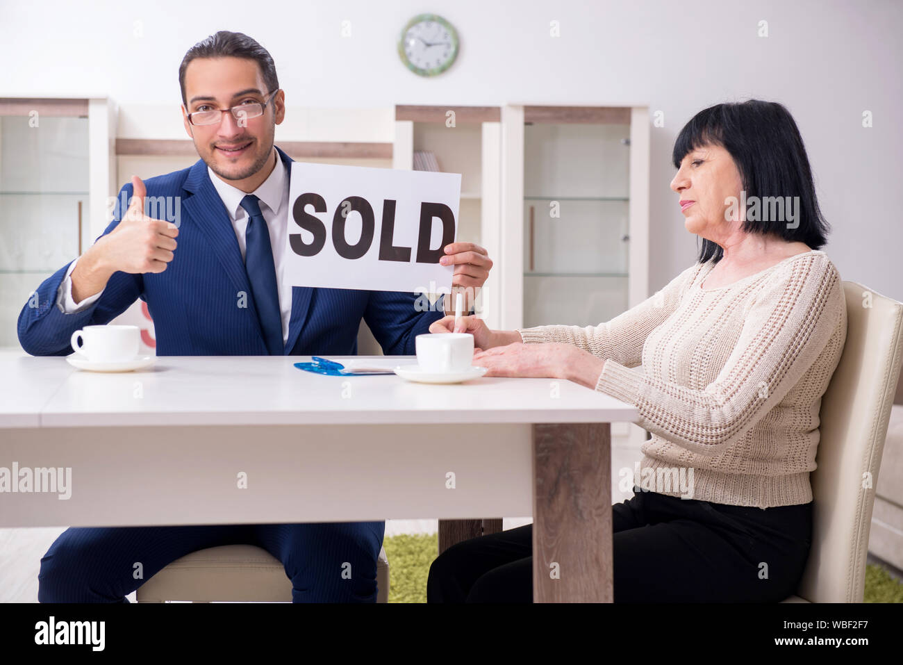 The male real estate agent and female client in the apartment Stock ...