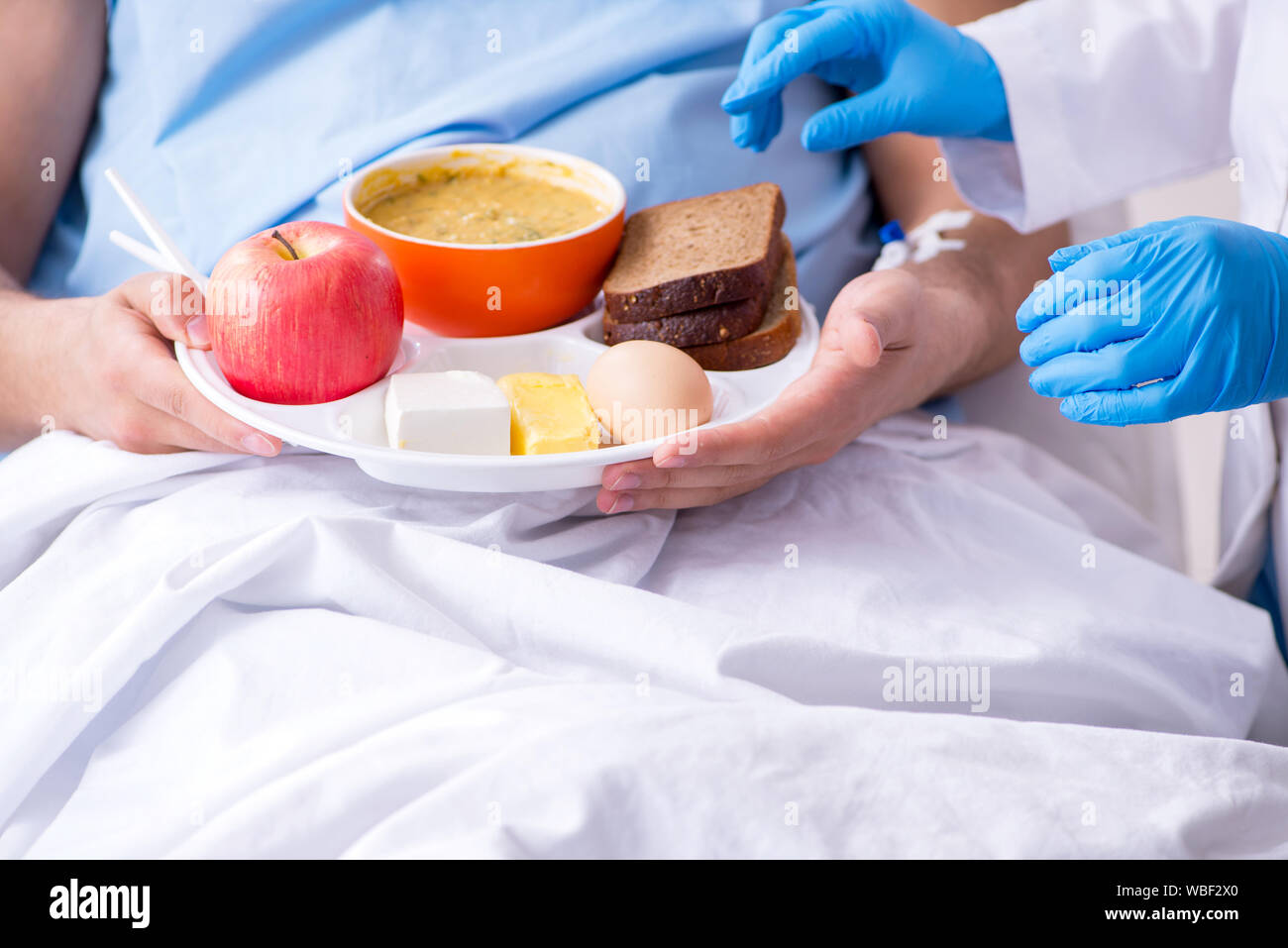 The male patient eating food in the hospital Stock Photo - Alamy