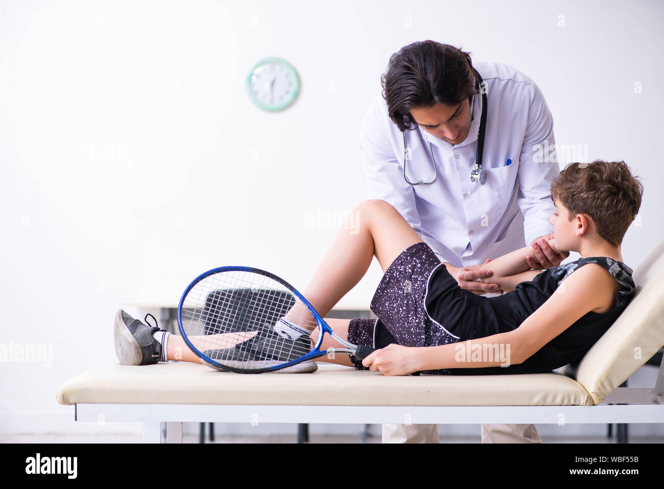 The boy tennis player visiting young doctor traumatologist Stock Photo ...
