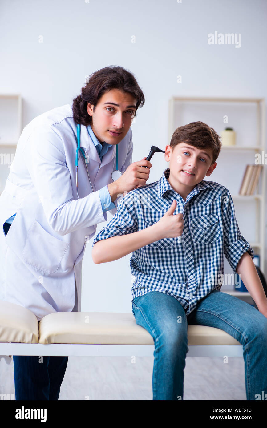 The male otolaryngologist examining boy's ear Stock Photo - Alamy