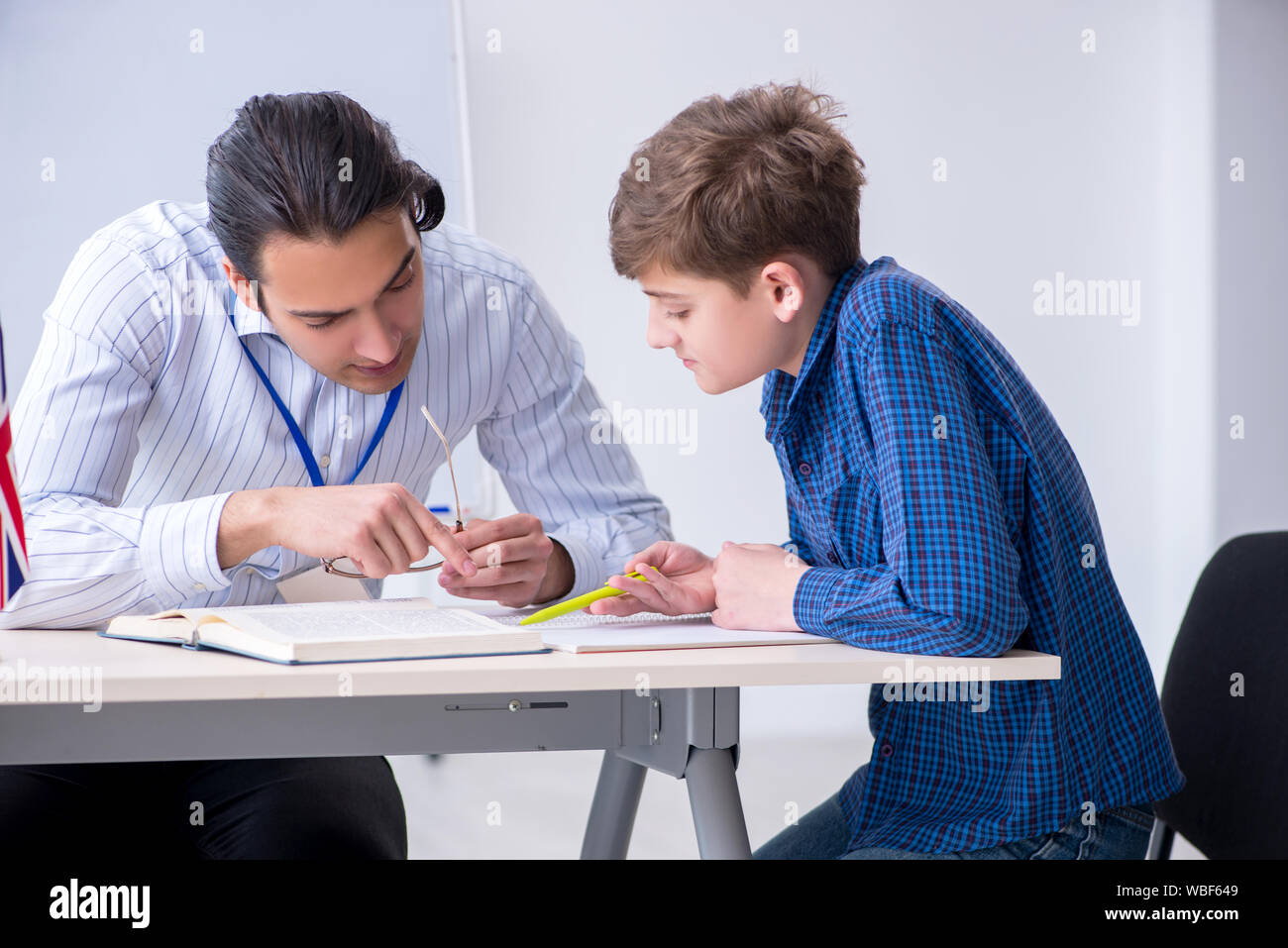 The male english teacher and boy in the classroom Stock Photo - Alamy