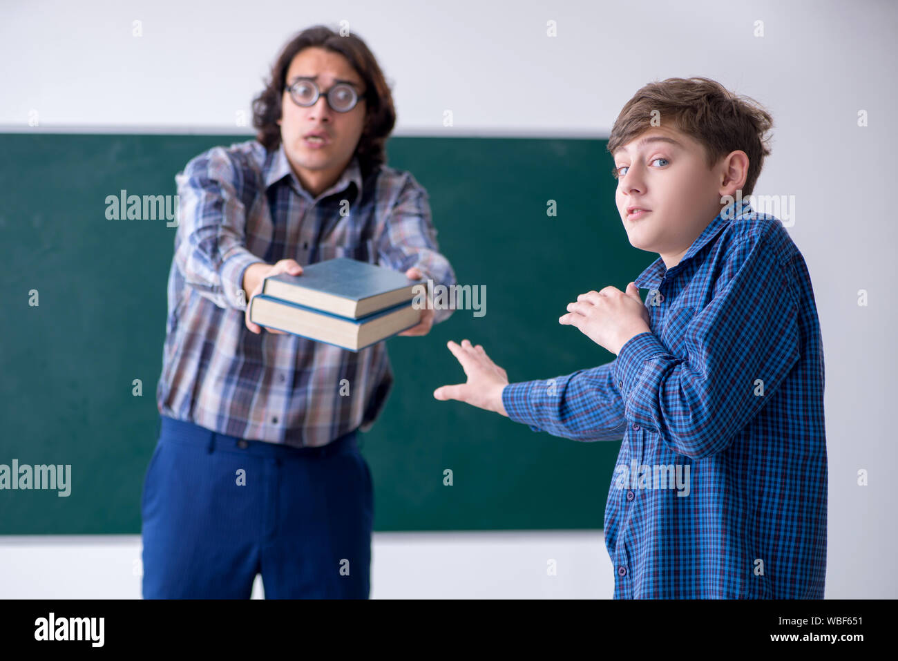 The funny male teacher and boy in the classroom Stock Photo - Alamy