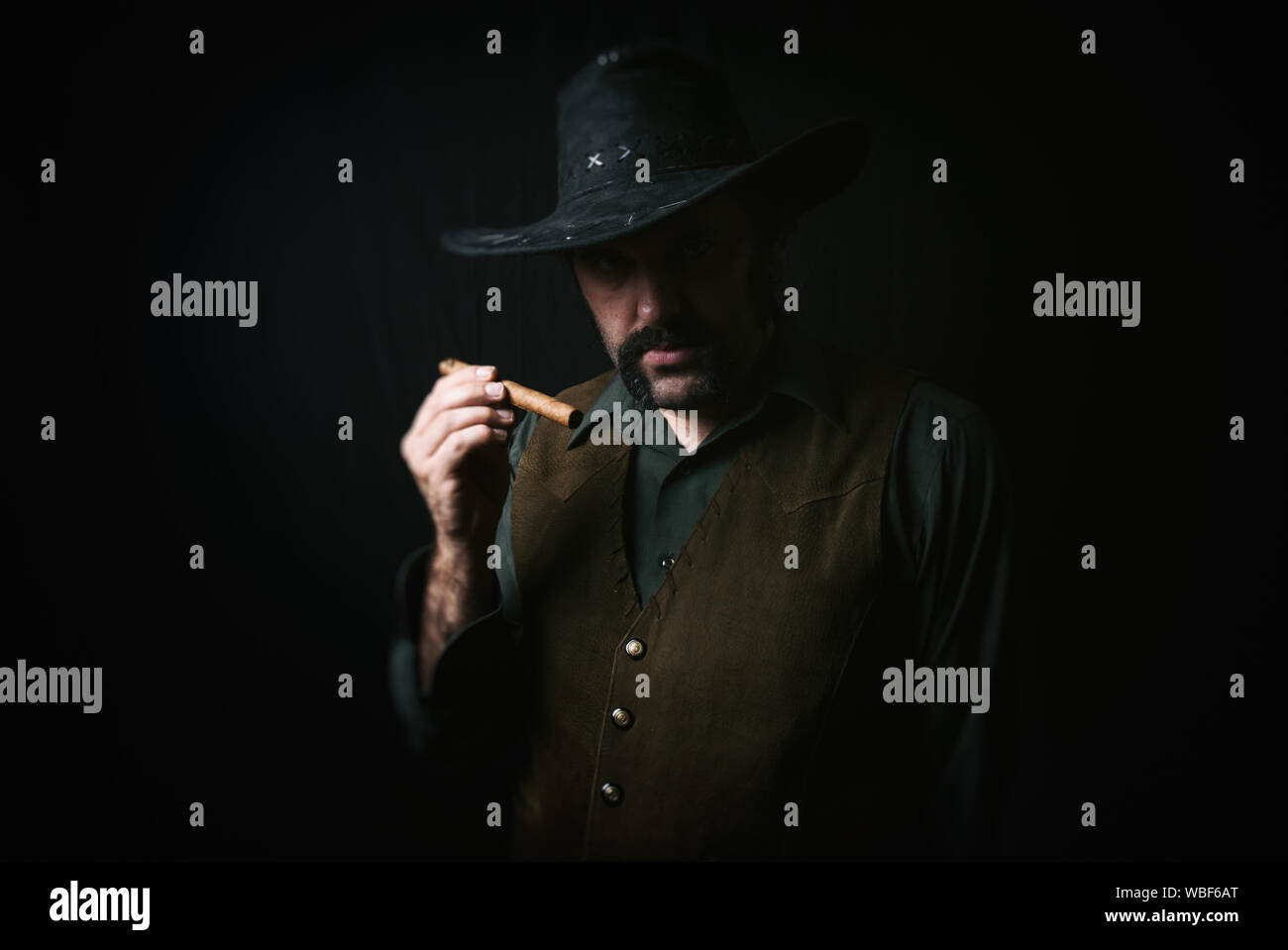 Cowboy with mustache smoking cigar hi-res stock photography and images ...