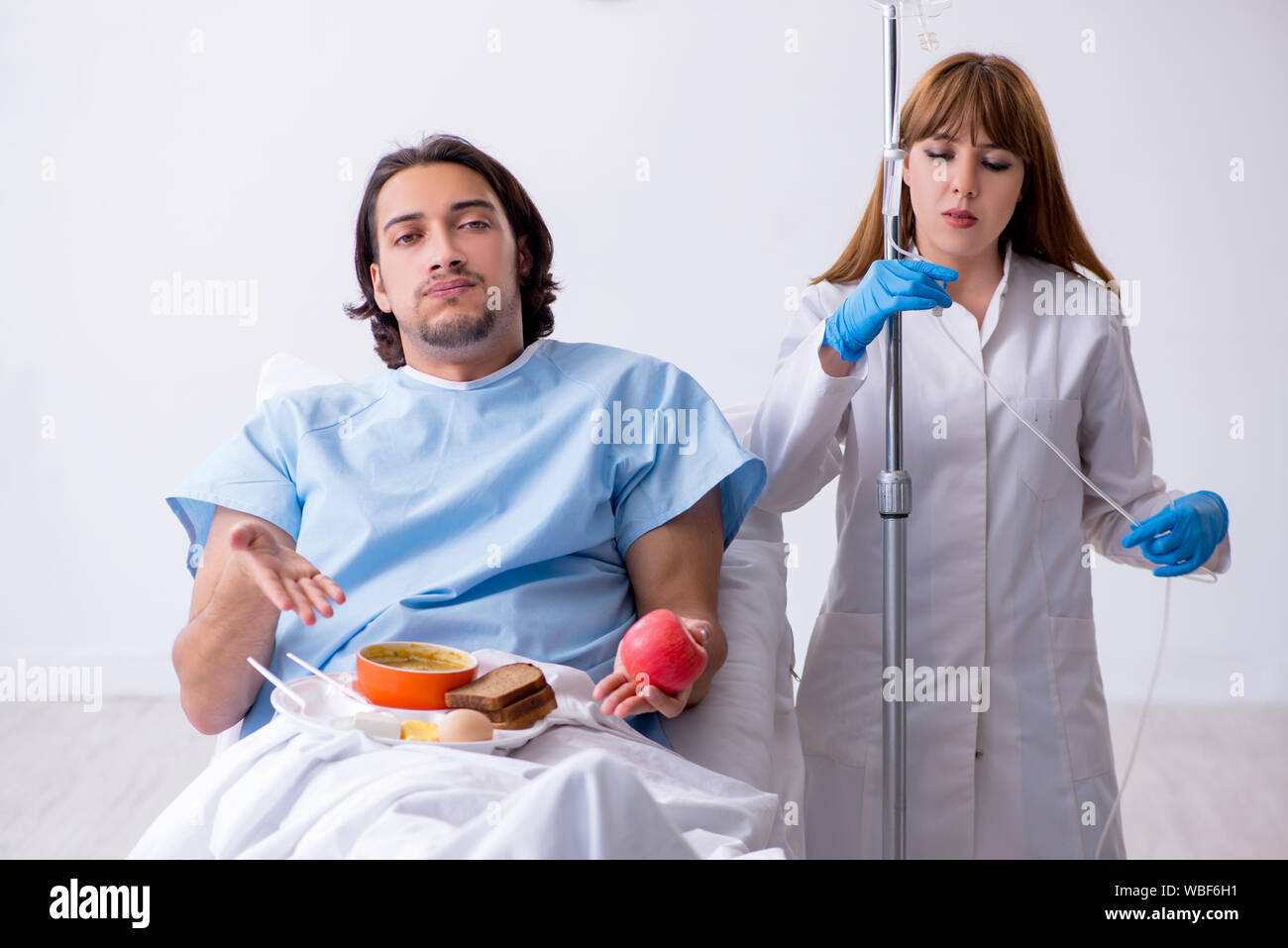 The male patient eating food in the hospital Stock Photo - Alamy