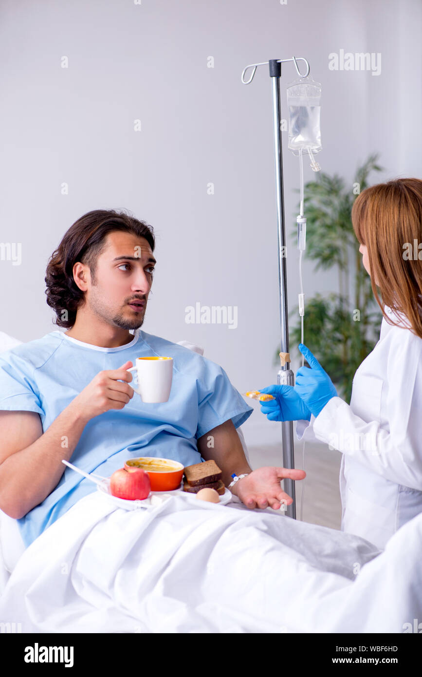 The male patient eating food in the hospital Stock Photo - Alamy