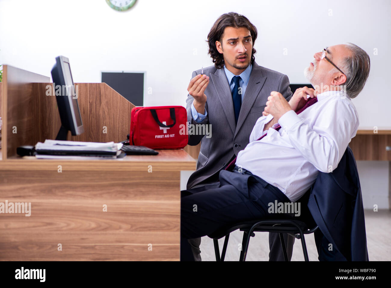 The male employee suffering from heart attack in the office Stock Photo ...