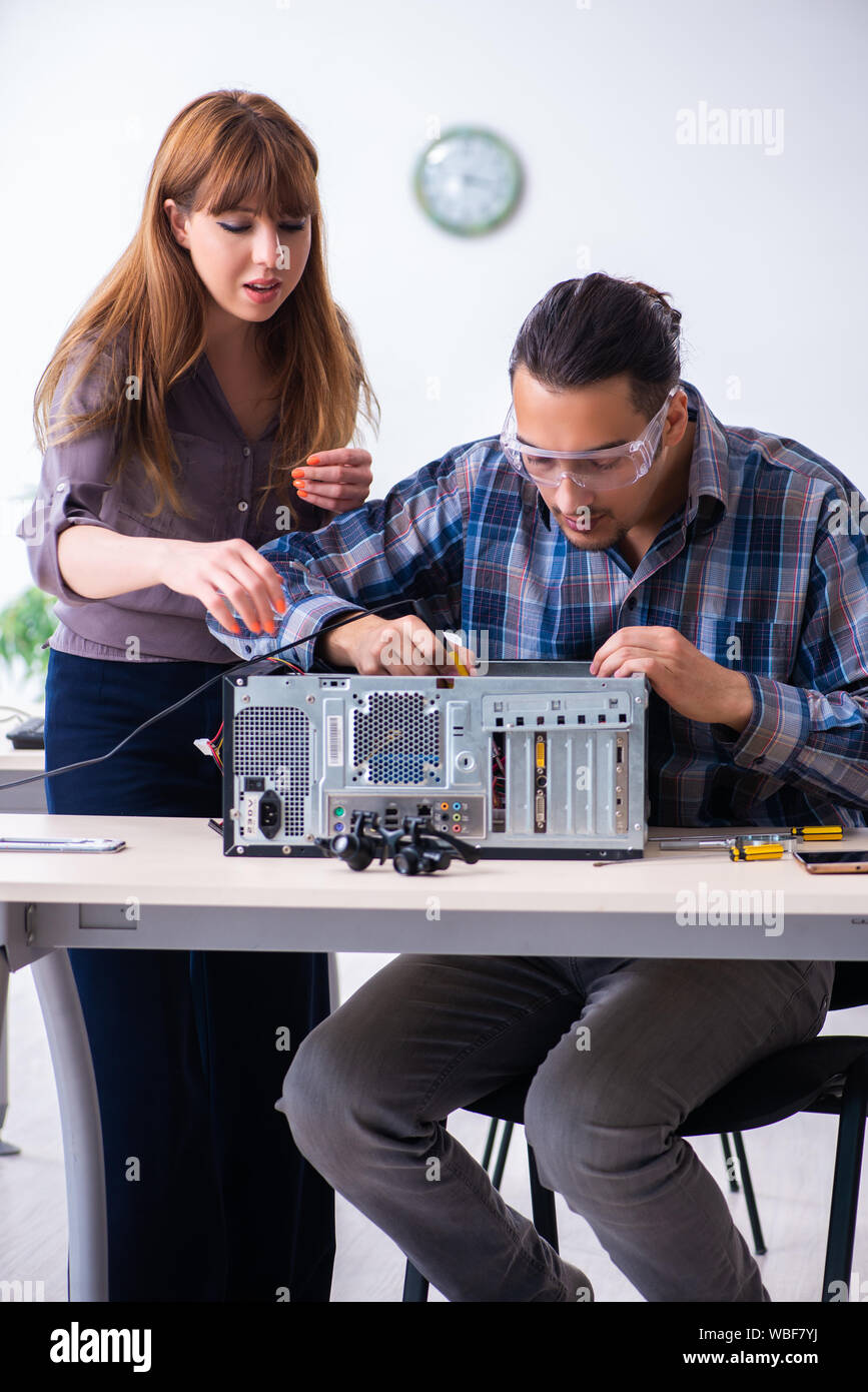 The two repairmen repairing desktop computer Stock Photo - Alamy