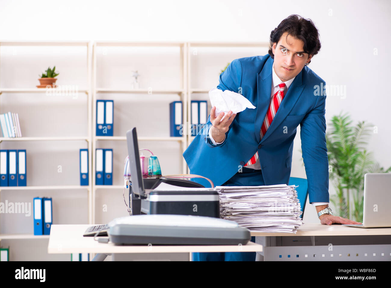 The young employee making copies at copying machine Stock Photo - Alamy