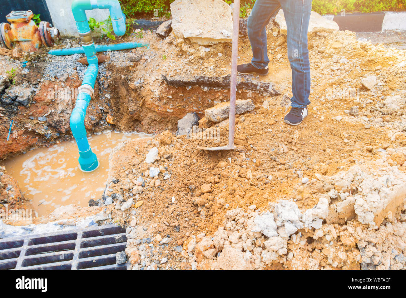 worker repair pipe plumbing water main broken. Use shovel to dig a hole ...