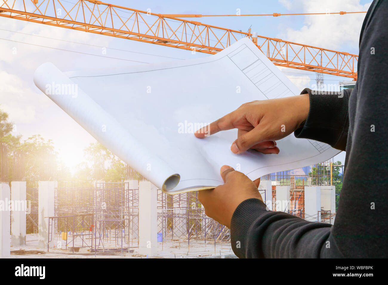engineer finger point on paper plan blueprint in check building ...