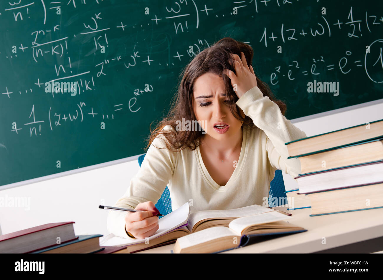 The young female math teacher in front of chalkboard Stock Photo - Alamy