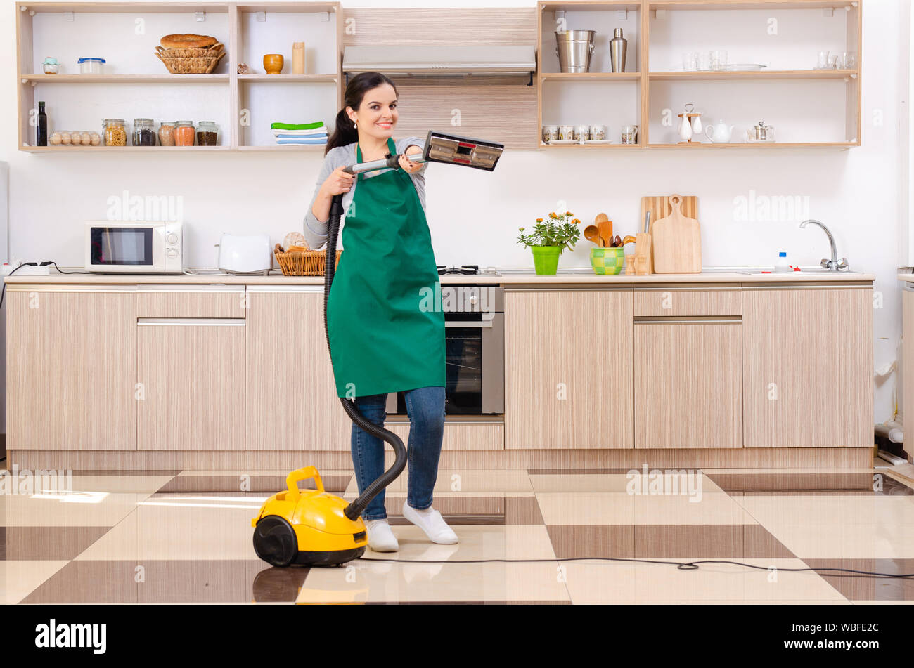The young female contractor doing housework Stock Photo - Alamy