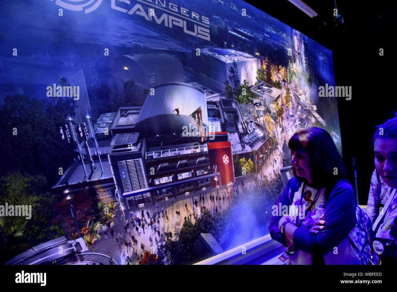 Visitors look at a rendering of Avengers Campus, the Marvel-themed ...