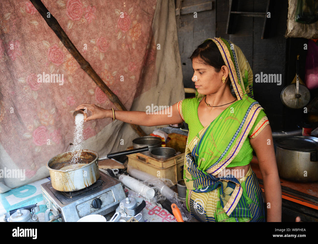 An Indian woman preparing Chai in a small Tea-shop in Varanasi, India ...