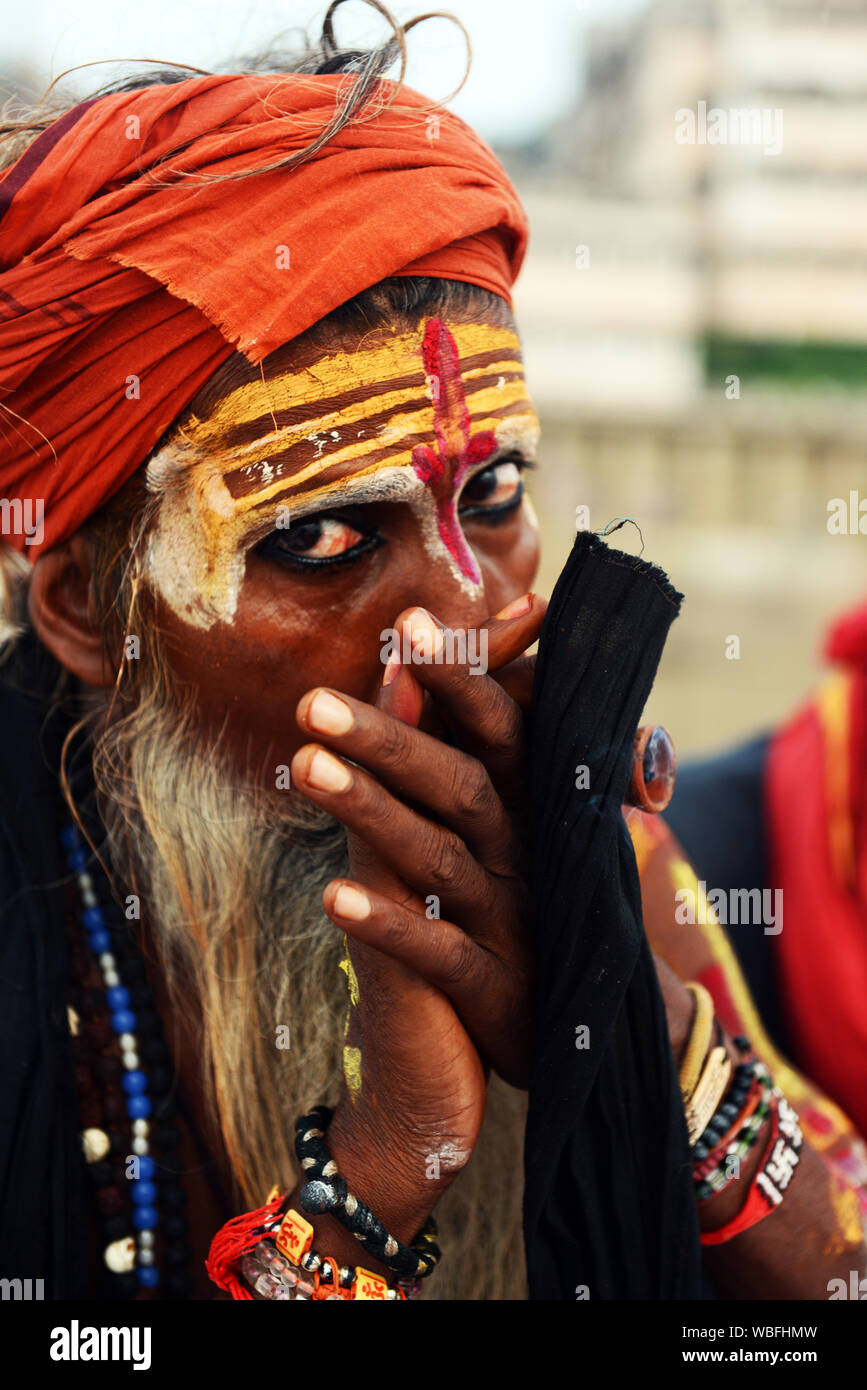 A Shaiva Sadhu smoking Chillum on the Ganges river in Varanasi, India ...