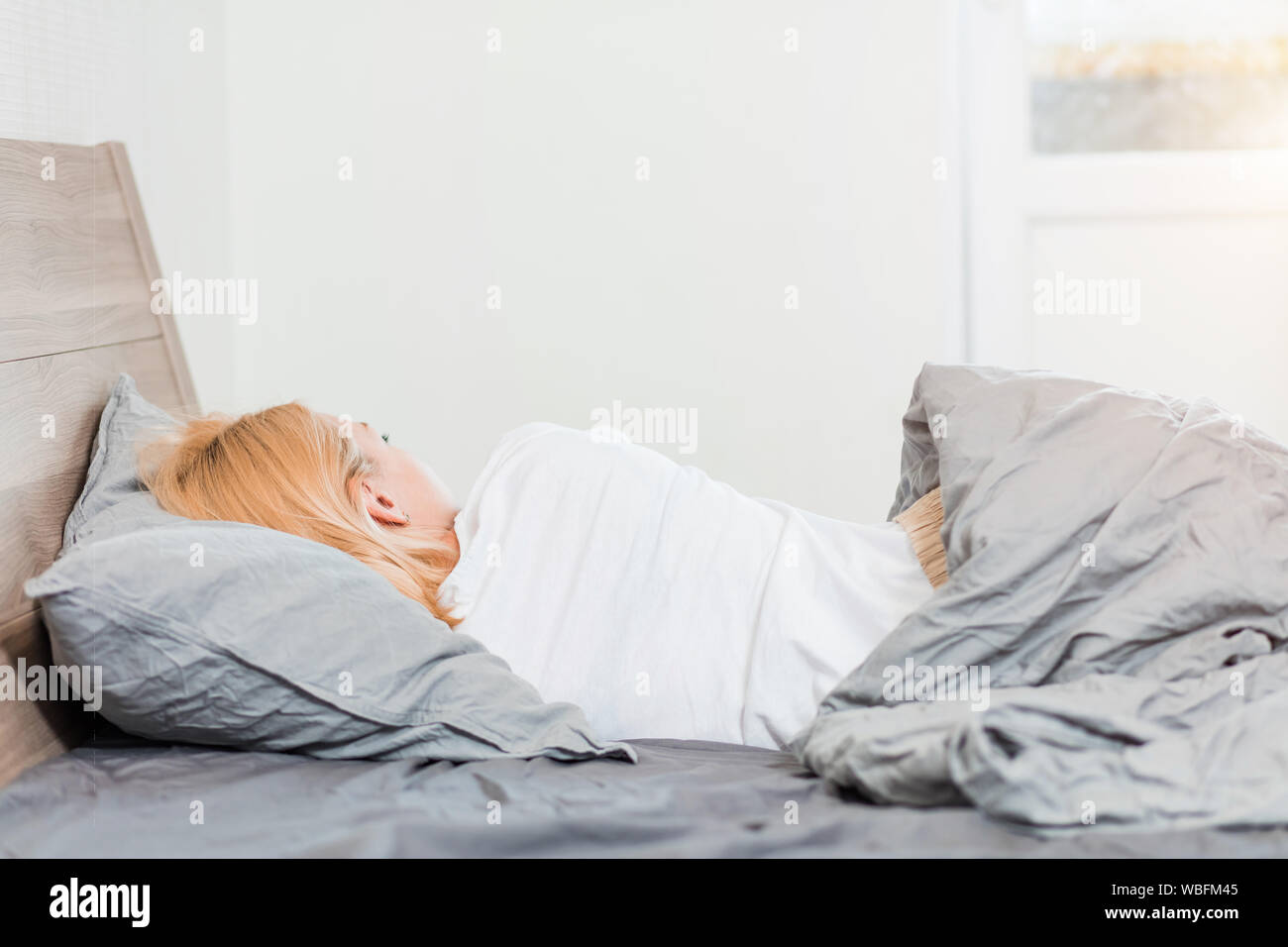Woman sleeping in bed back view hi-res stock photography and images - Alamy