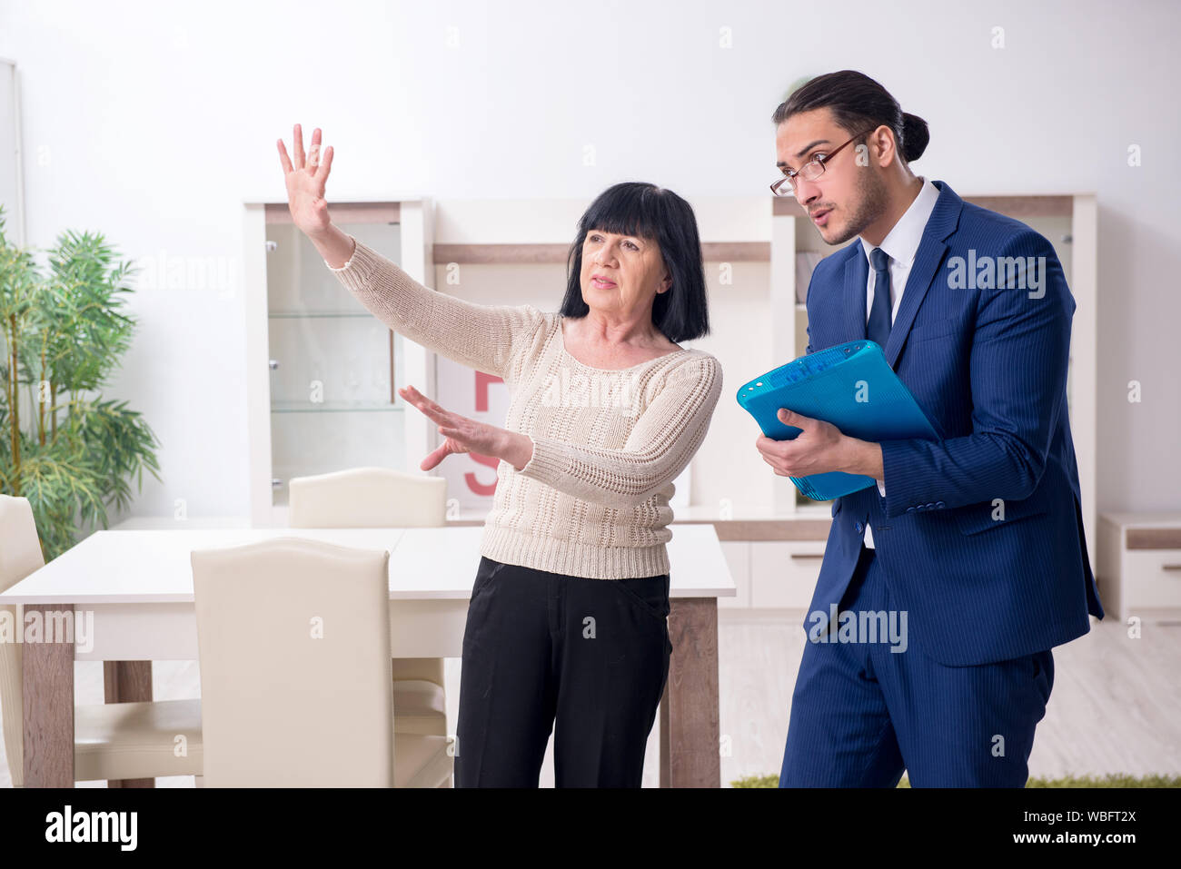 The male real estate agent and female client in the apartment Stock ...
