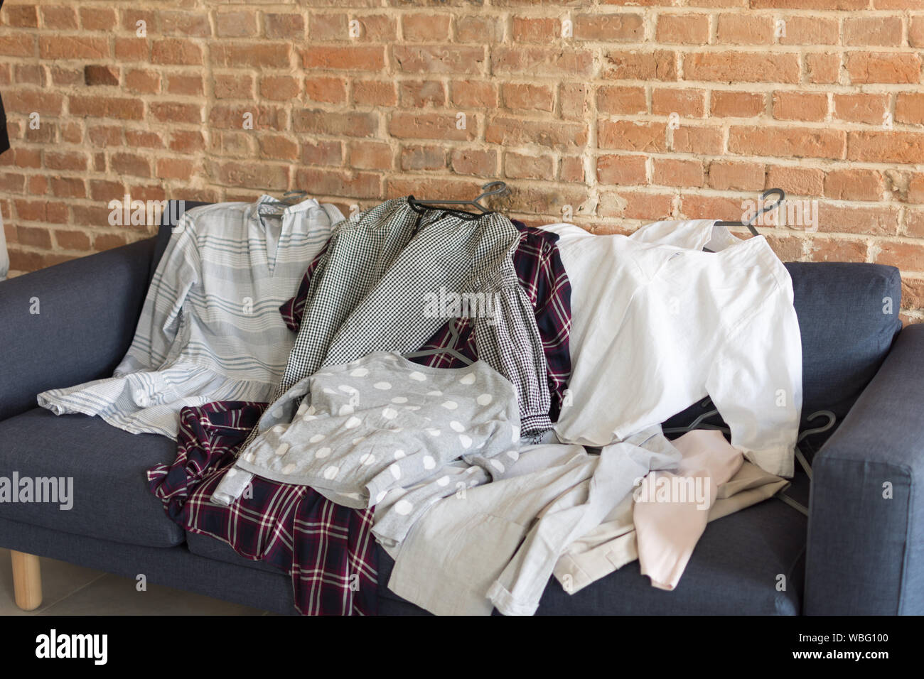 Mess of clothers on the sofa. What to wear concept. Messy colorful ...