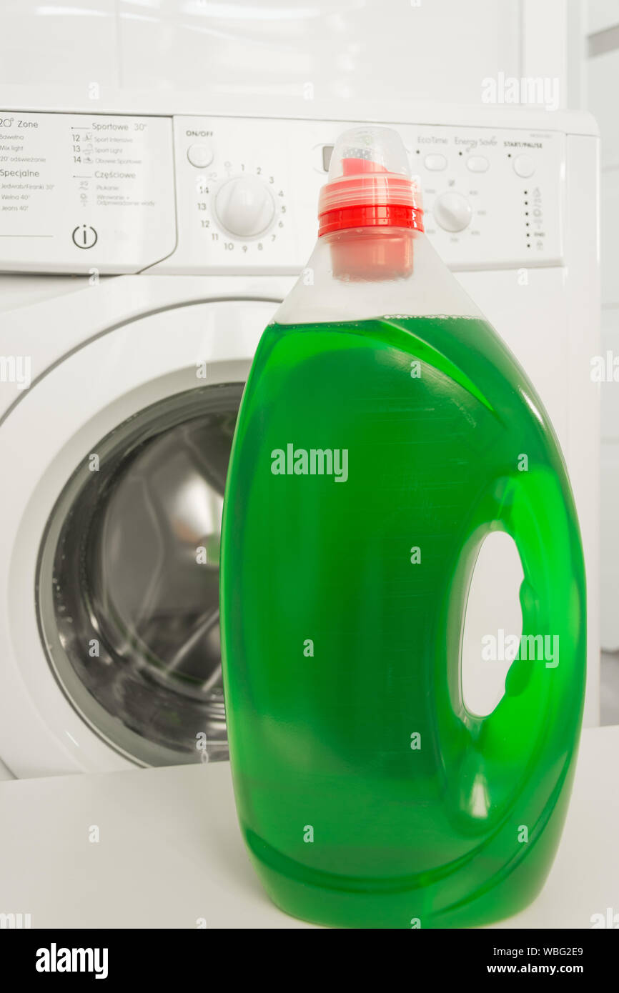 Bottle of washing gel against washing machine. Laundry green eco gel ...