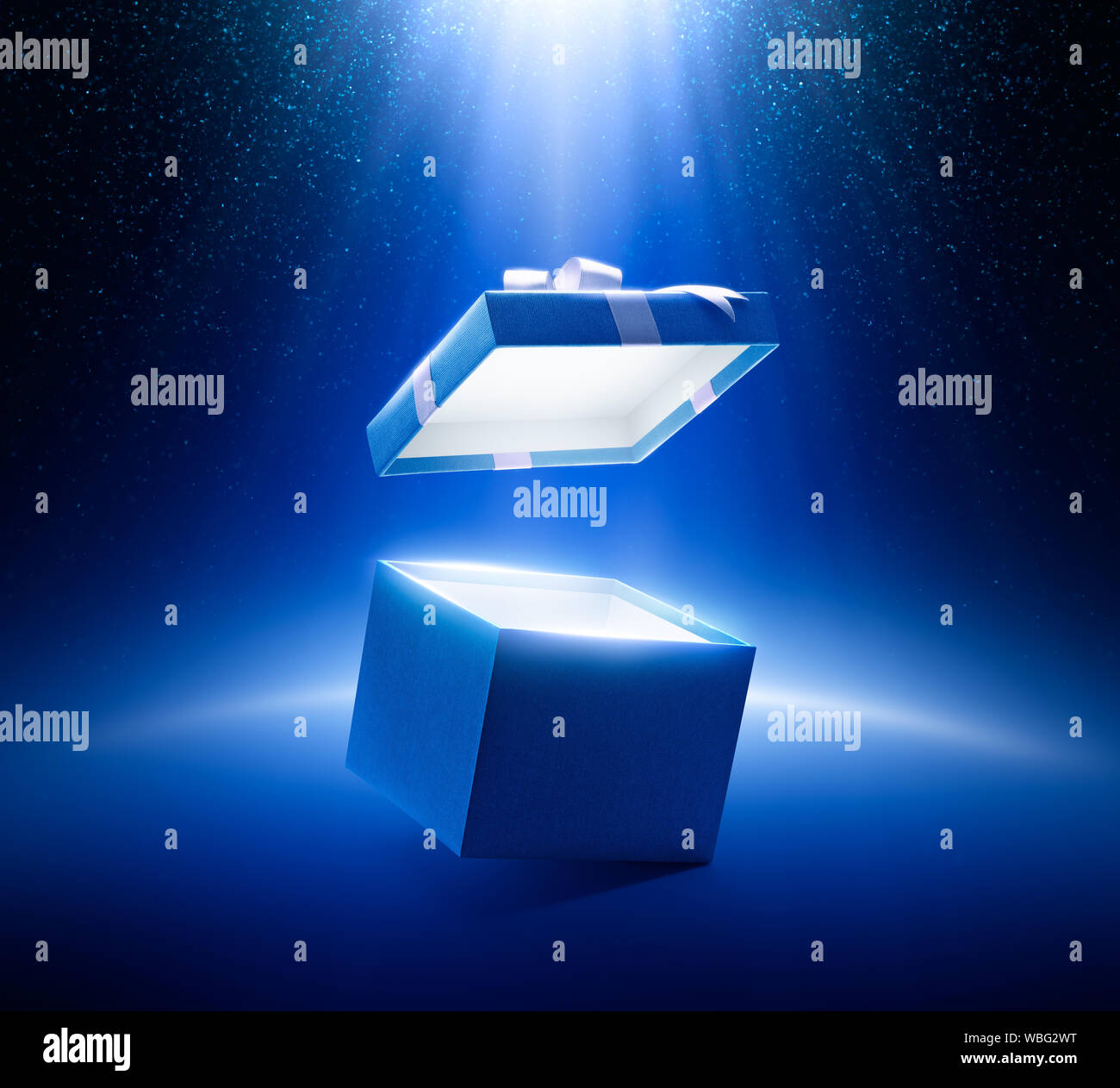Blue open gift box on glittering background Stock Photo - Alamy