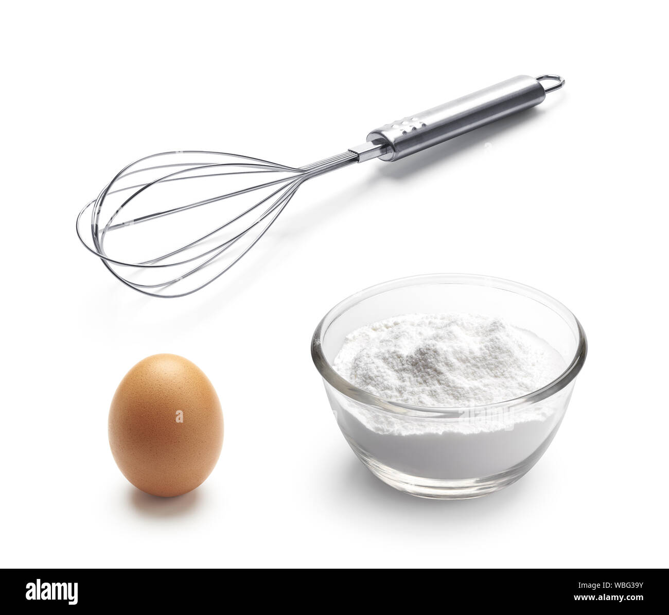 Baking ingredients - balloon whisk, egg and flour isolated on white ...