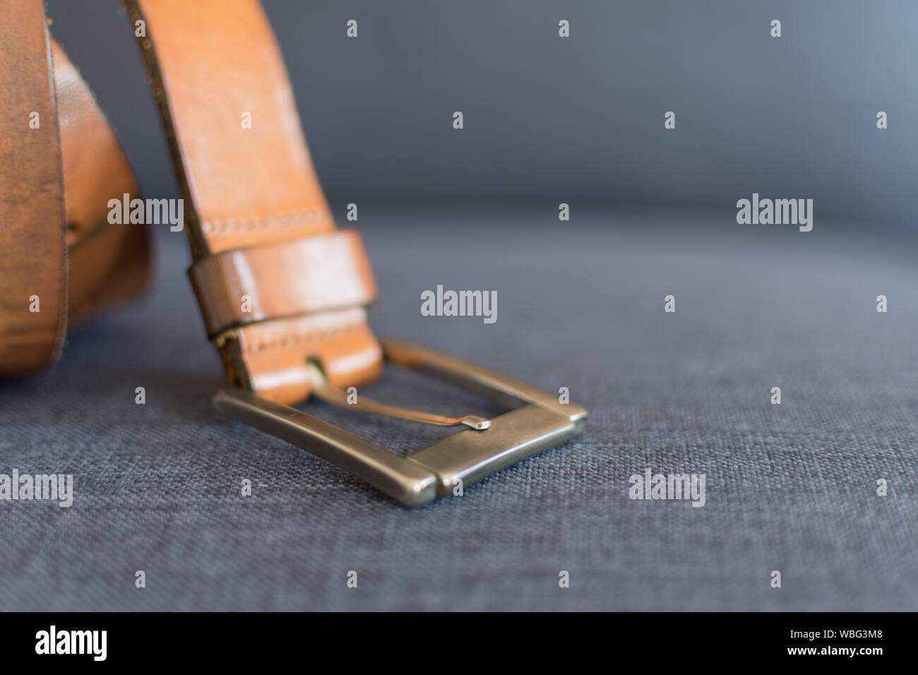 Leather men's belt on a blue fabric background. Brown vintage belt ...