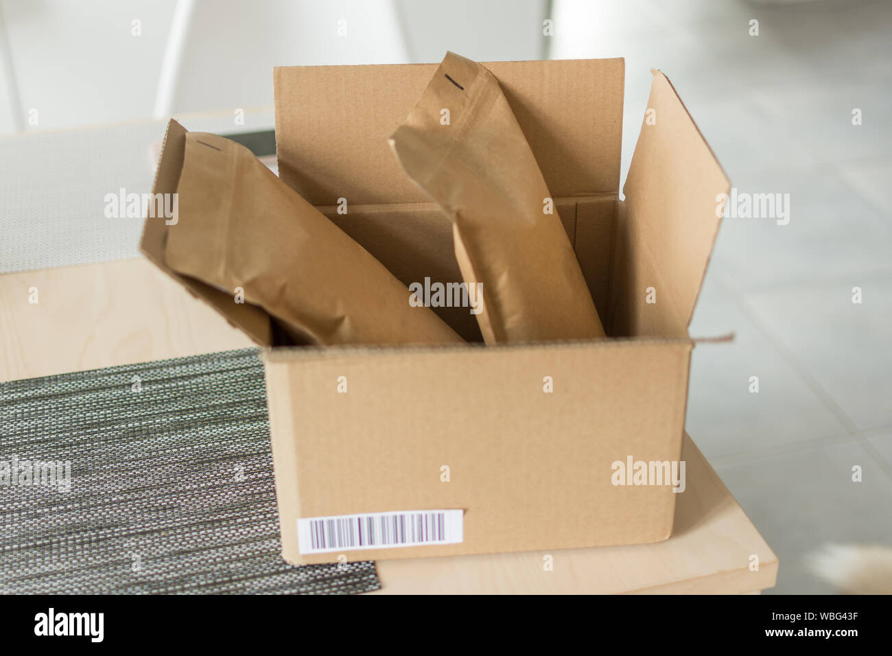 Opened cardboard over modern interior. Paper parcel opened indoors ...