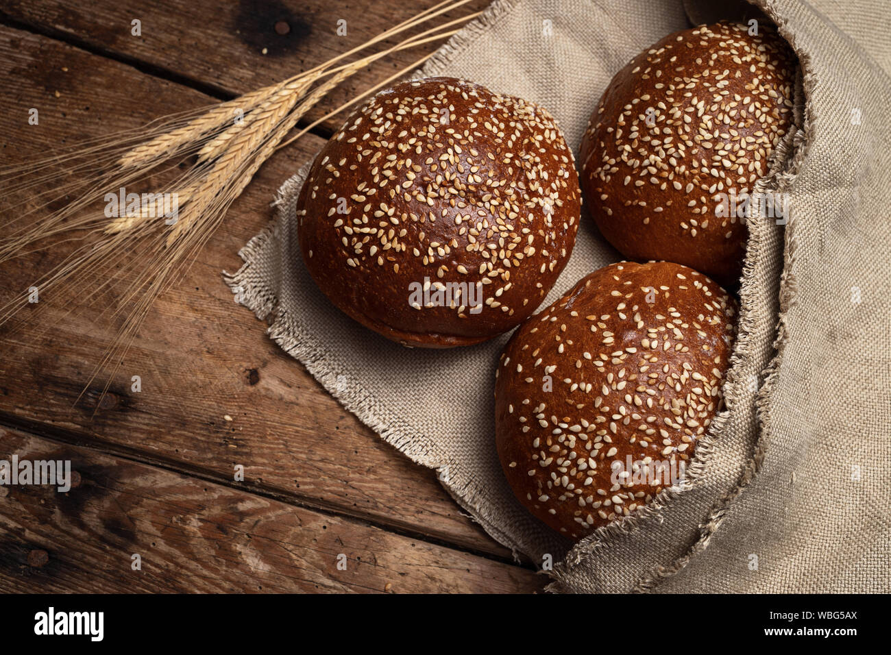 Homemade sourdough bread. Round buns isolated on wooden background ...