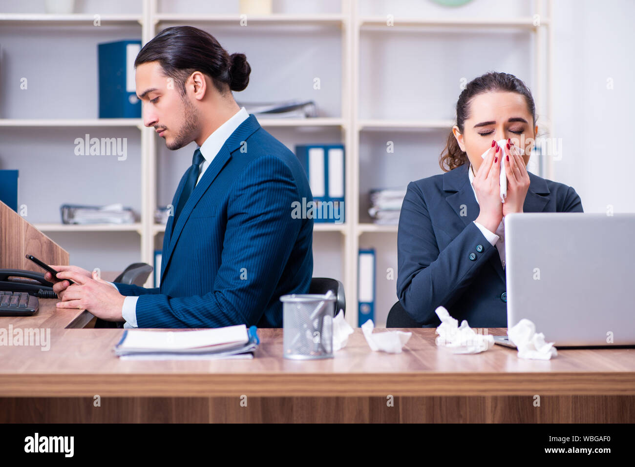 The two employees suffering at workplace Stock Photo - Alamy