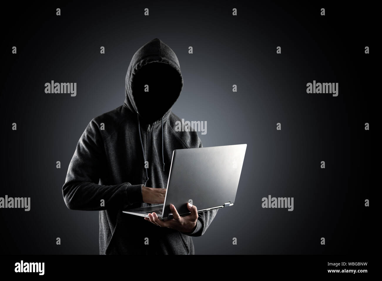 Cybercrime, hacking and technology crime. no face hacker with laptop on ...