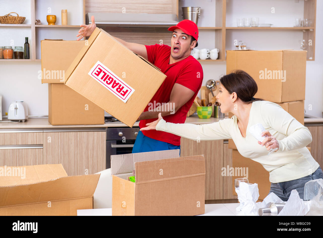 The young male contractor and female customer in moving concept Stock ...
