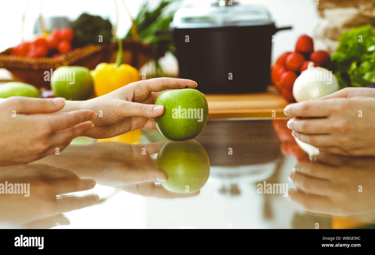 Closeup of human hands discussing something while cooking in kitchen ...