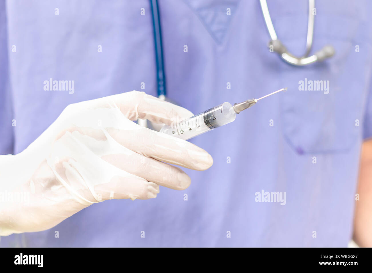 Doctor hand holding injection needle. Medical doctor picking up ...