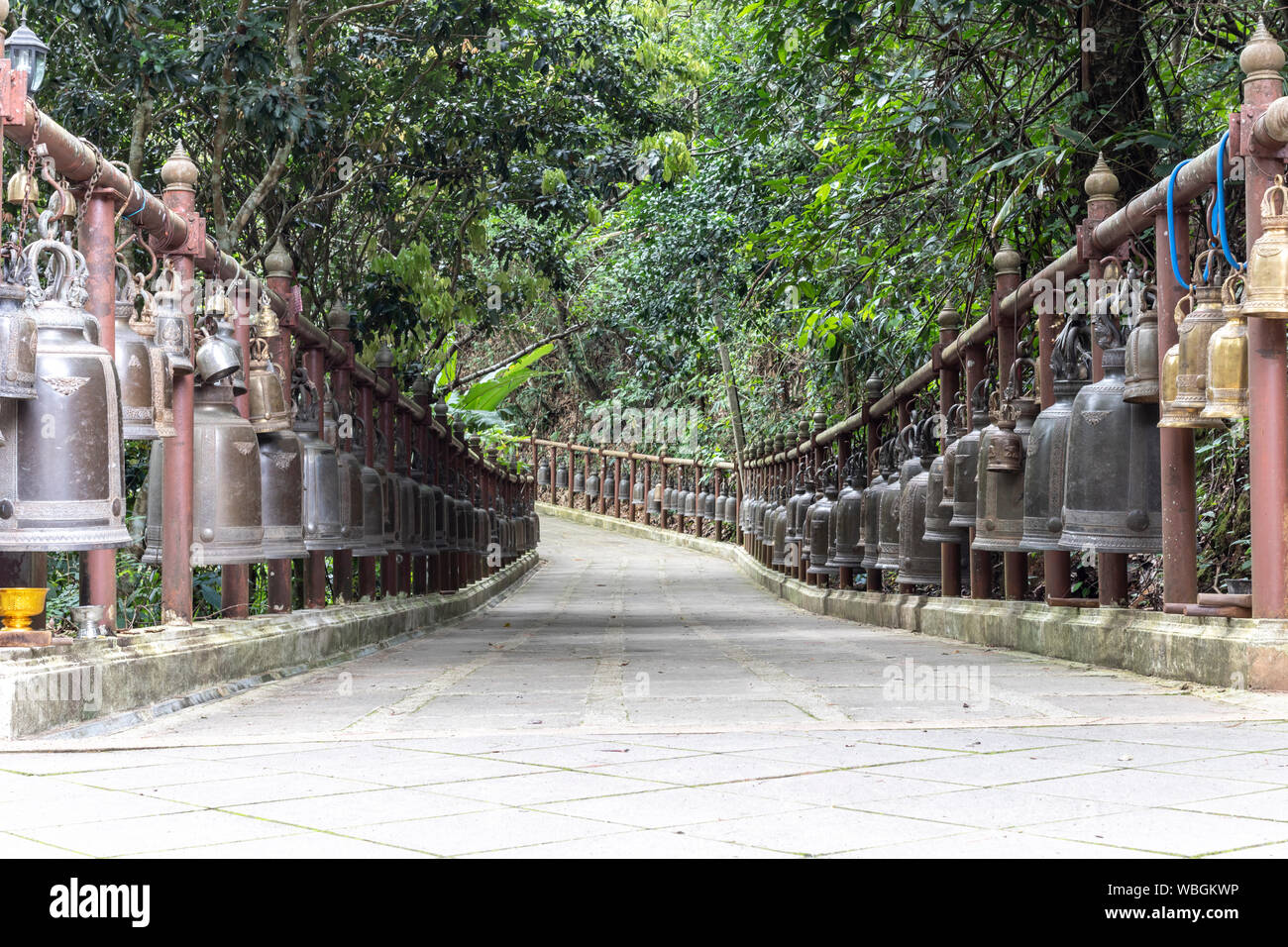 Walkways with many ancient bronze bells on both sides at Phra That Doi ...