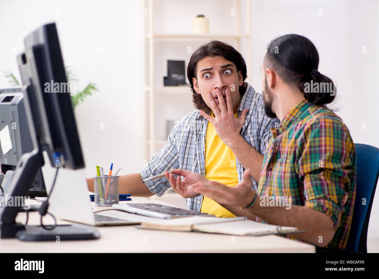 The two it specialists working in the office Stock Photo - Alamy