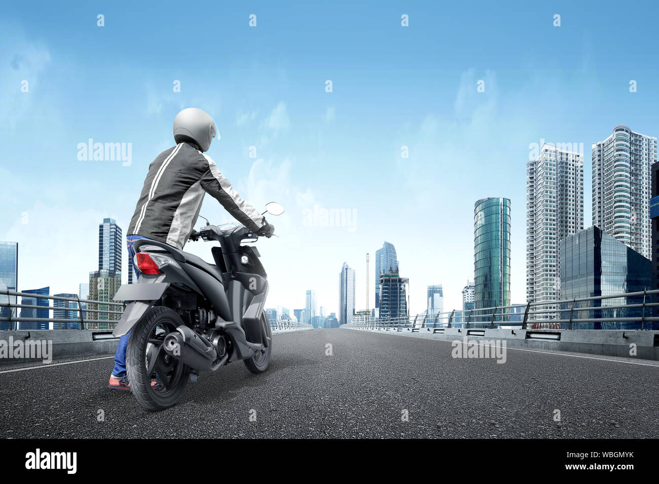 Rear view of Asian motorcycle taxi man pushes his motorcycle on the ...