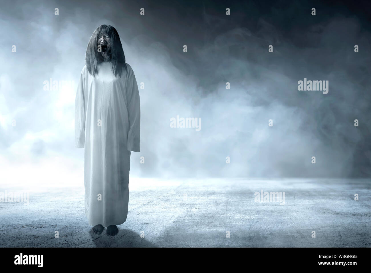 Scary ghost woman with blood and angry face standing in the dark room ...