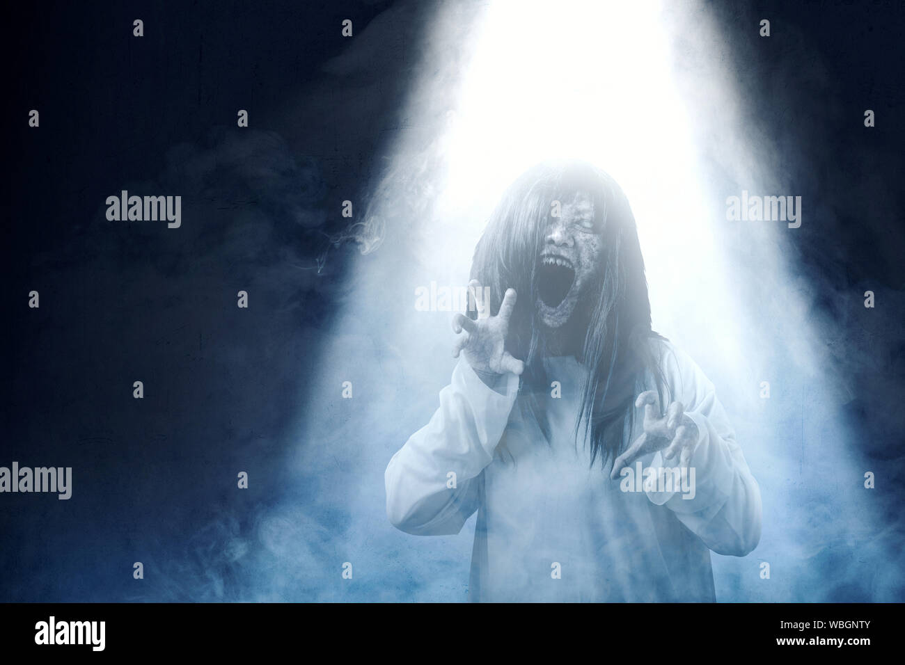 Scary ghost woman with blood and angry face with clawing hands standing ...