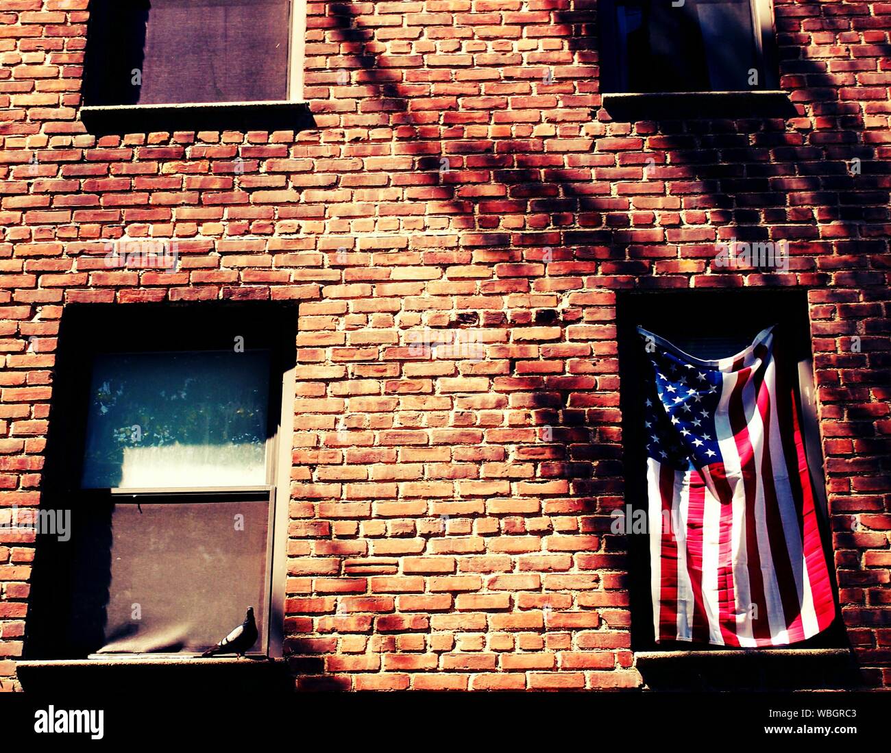Low Angle View Of Window Covered With American Flag Stock Photo - Alamy